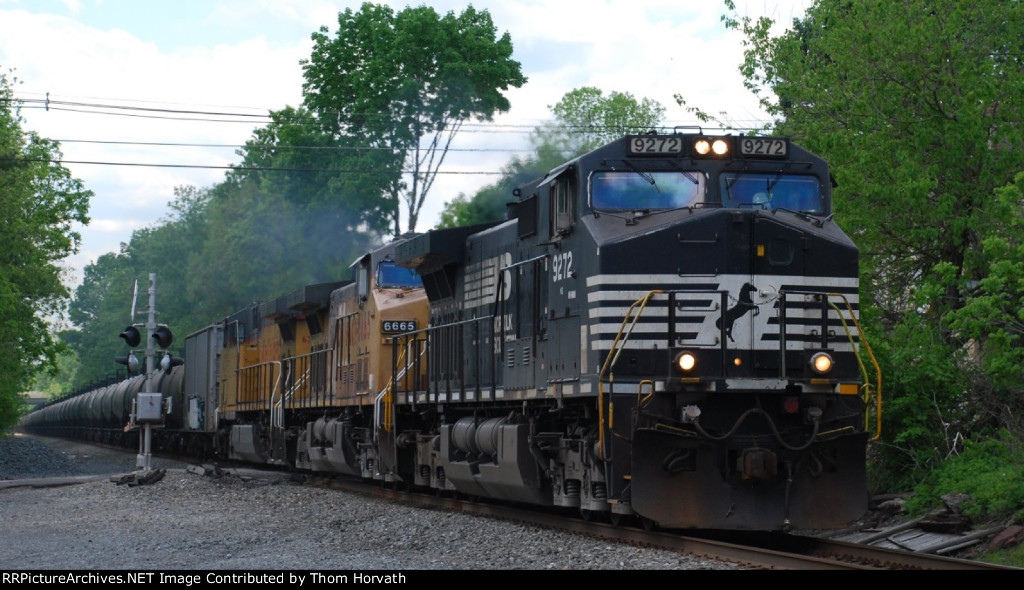 NSNS 64K is eastbound through the Main Street grade crossing